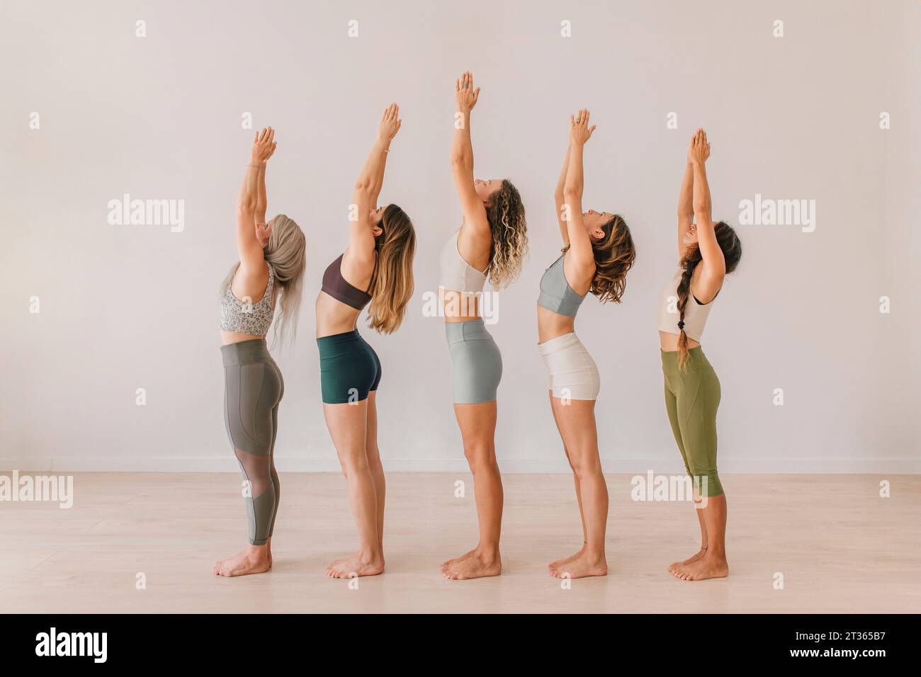 Five people standing with their arms raised hi-res stock photography ...