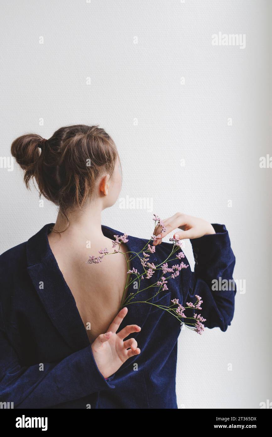 Teenage girl wearing navy blue blazer backwards with flowers on her ...
