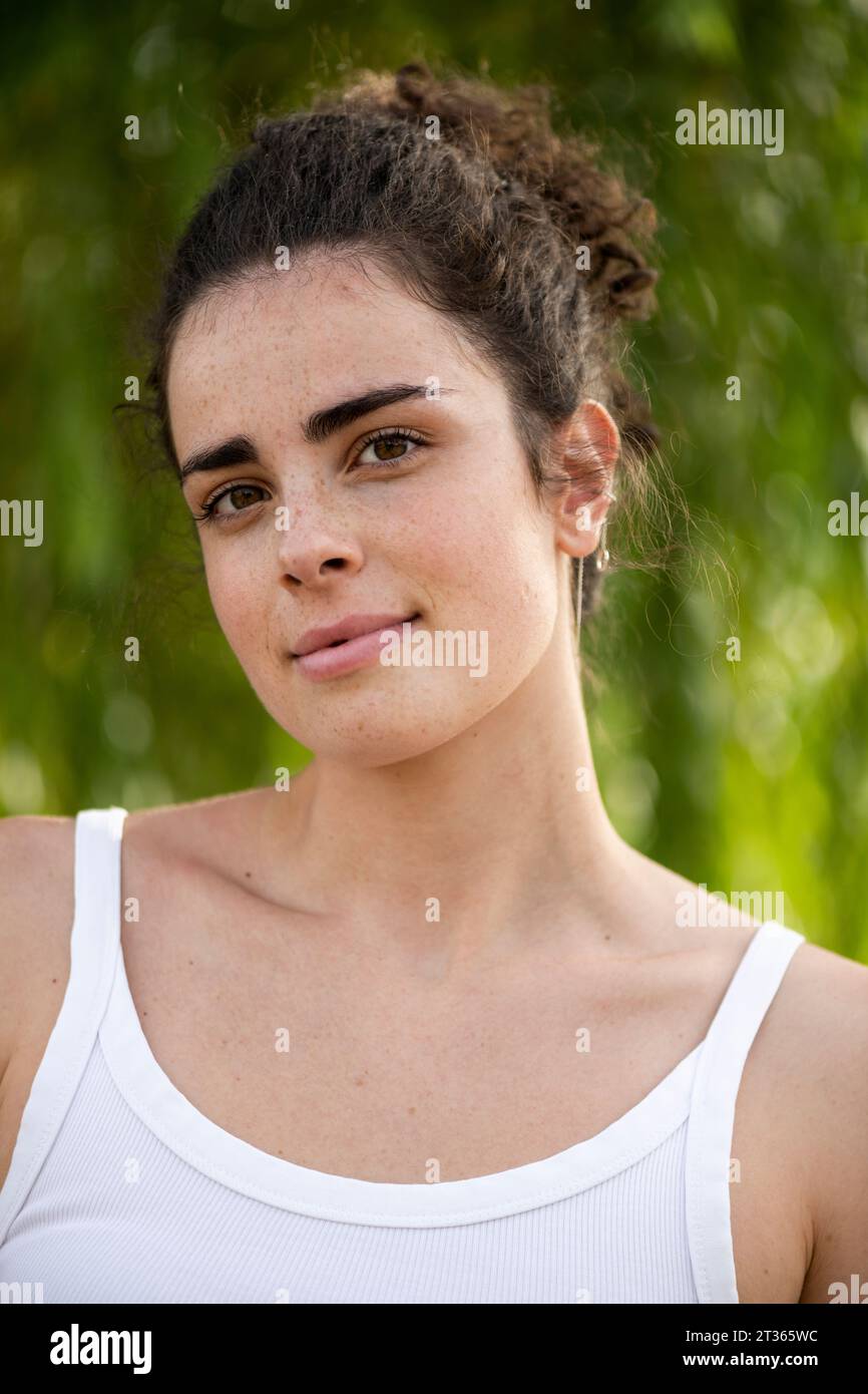 Smiling young beautiful woman wearing tank top Stock Photo - Alamy