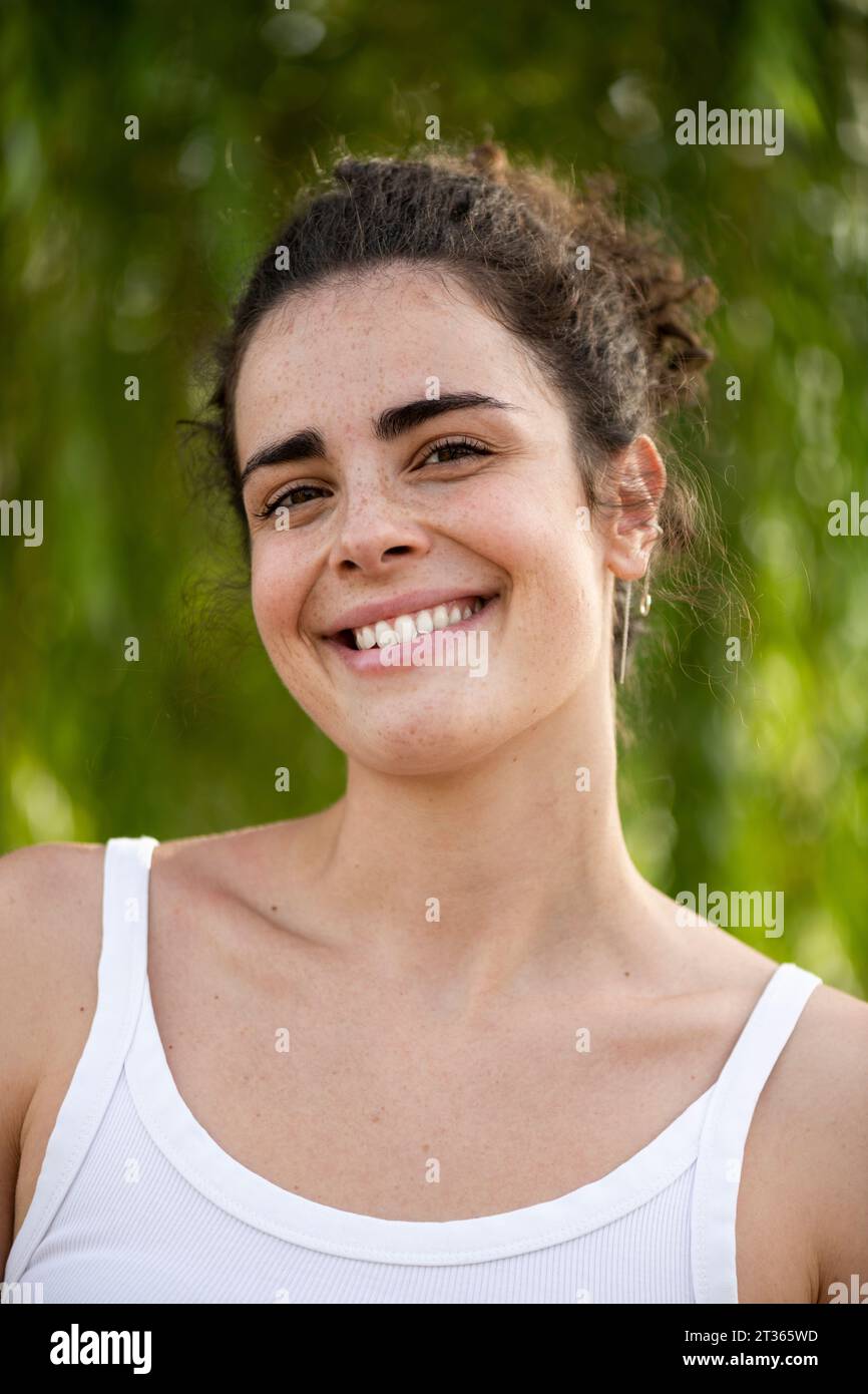 Happy young beautiful woman wearing tank top Stock Photo - Alamy