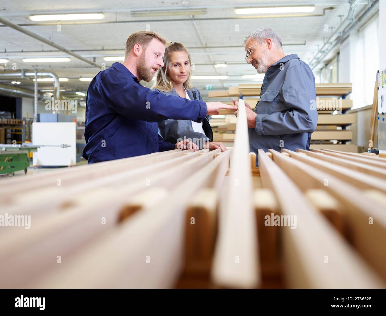 Carpenters examining wooden plank hi-res stock photography and images ...