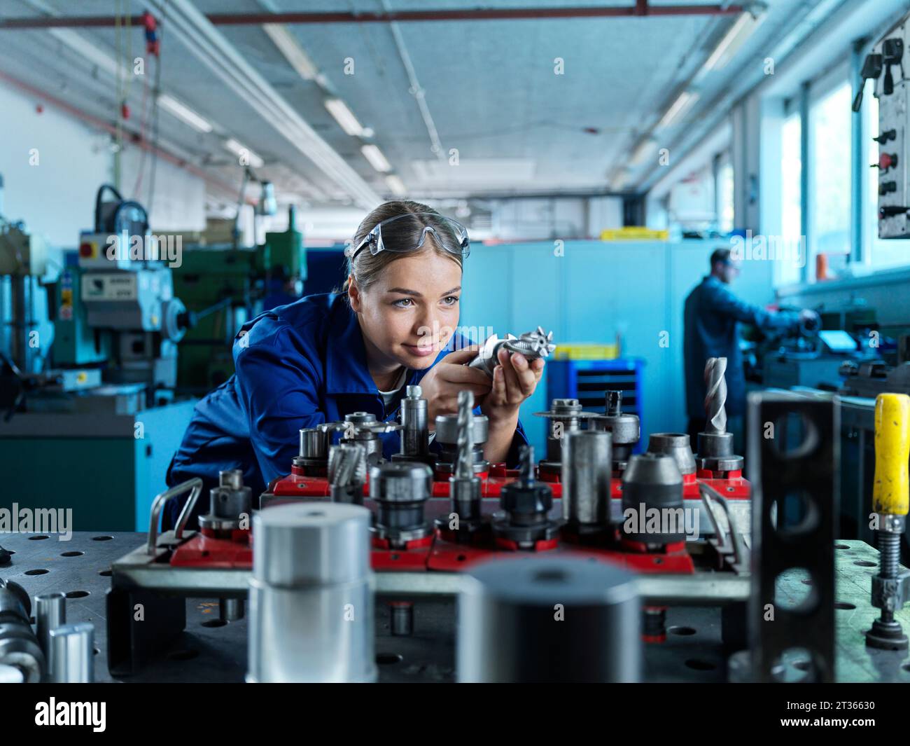 Metal worker learning to control CNC tool in factory Stock Photo - Alamy