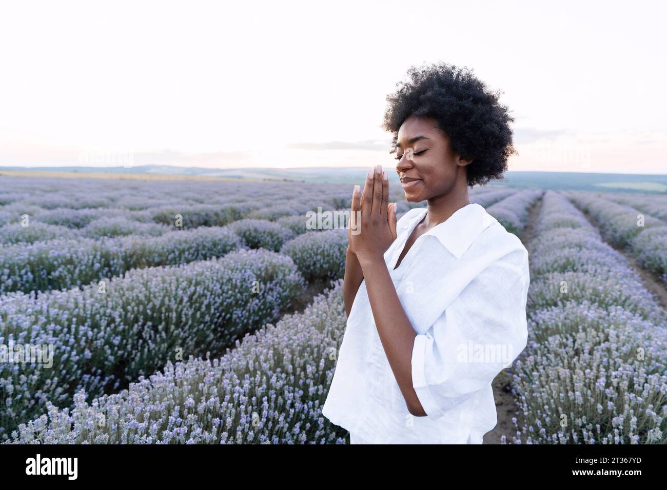 Standing in prayer yoga hi-res stock photography and images - Alamy