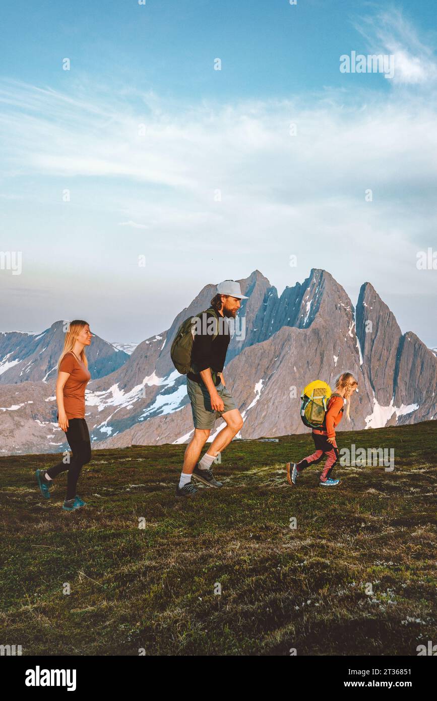 Family hiking in mountains outdoor parents and child together traveling ...