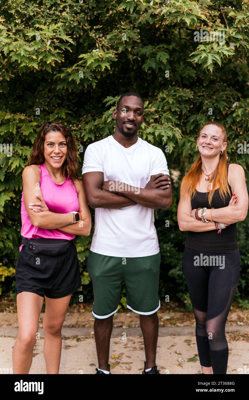 Portrait happy friends standing arms hi-res stock photography and ...