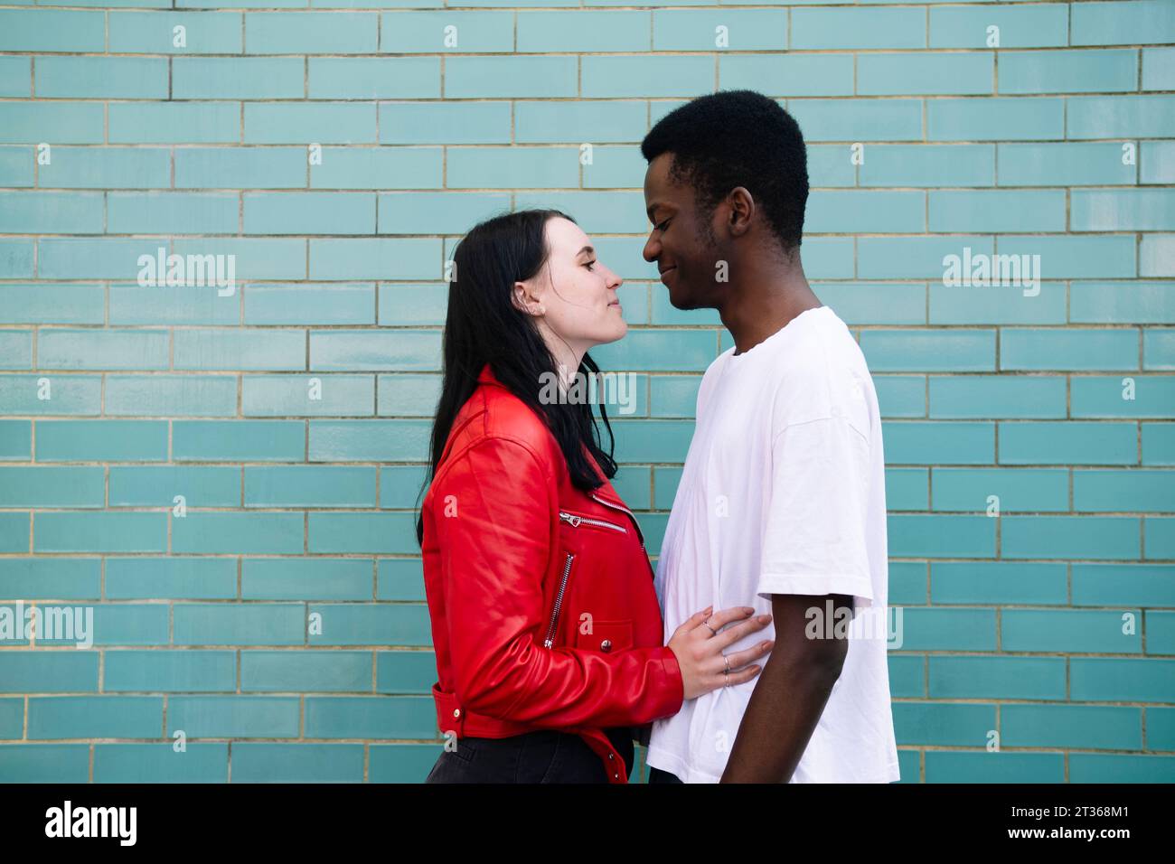 Couple standing near red brick hi-res stock photography and images - Alamy