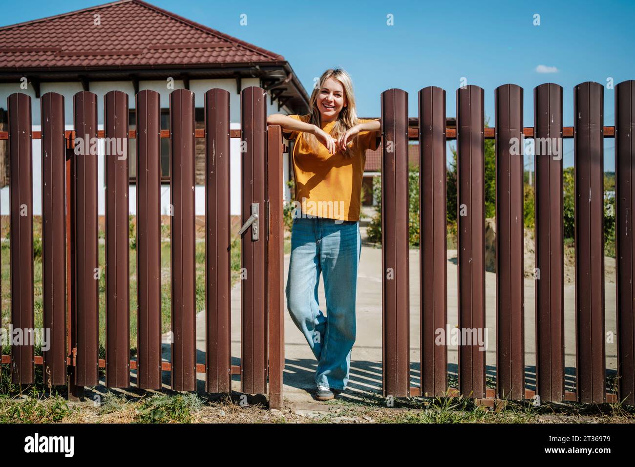 Female standing by a fence hi-res stock photography and images - Alamy