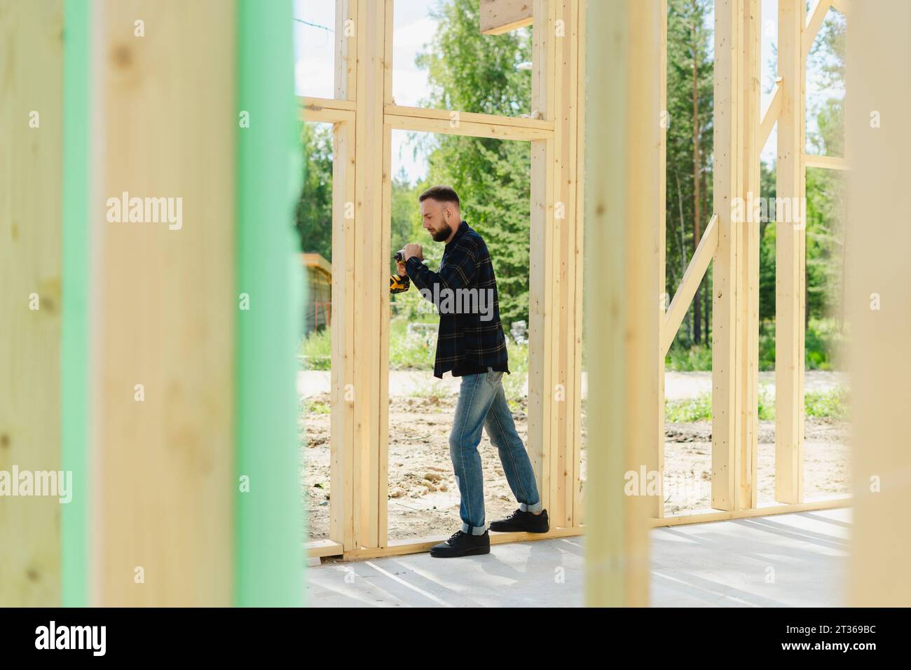 Engineer working on wood at construction site Stock Photo - Alamy