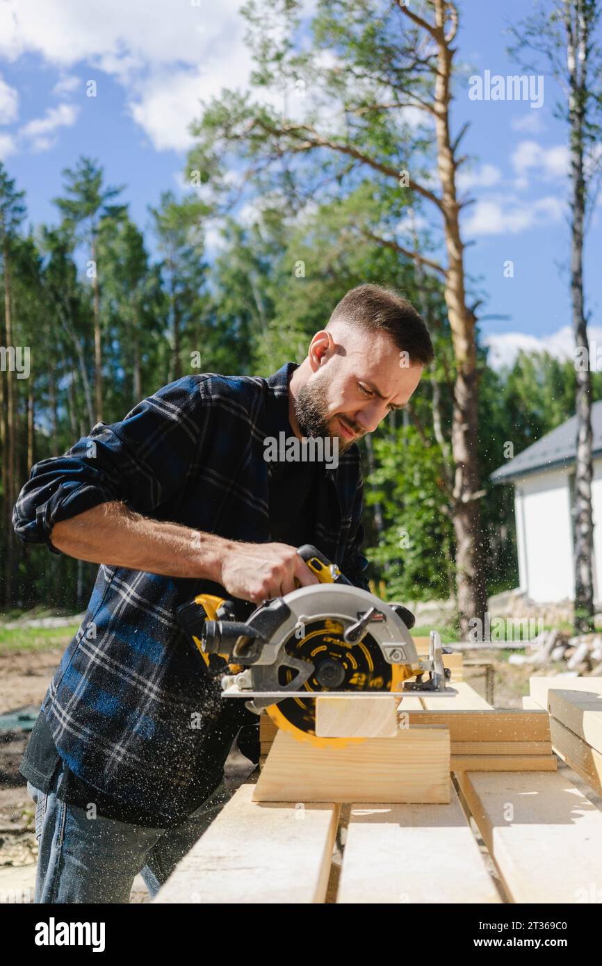 Engineer working with equipment on wood at construction site Stock ...