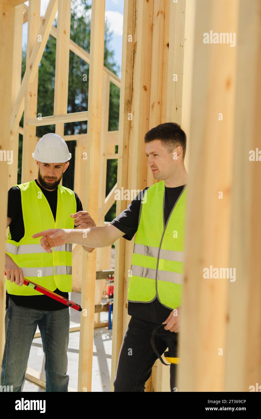Engineers having discussion at construction site Stock Photo - Alamy