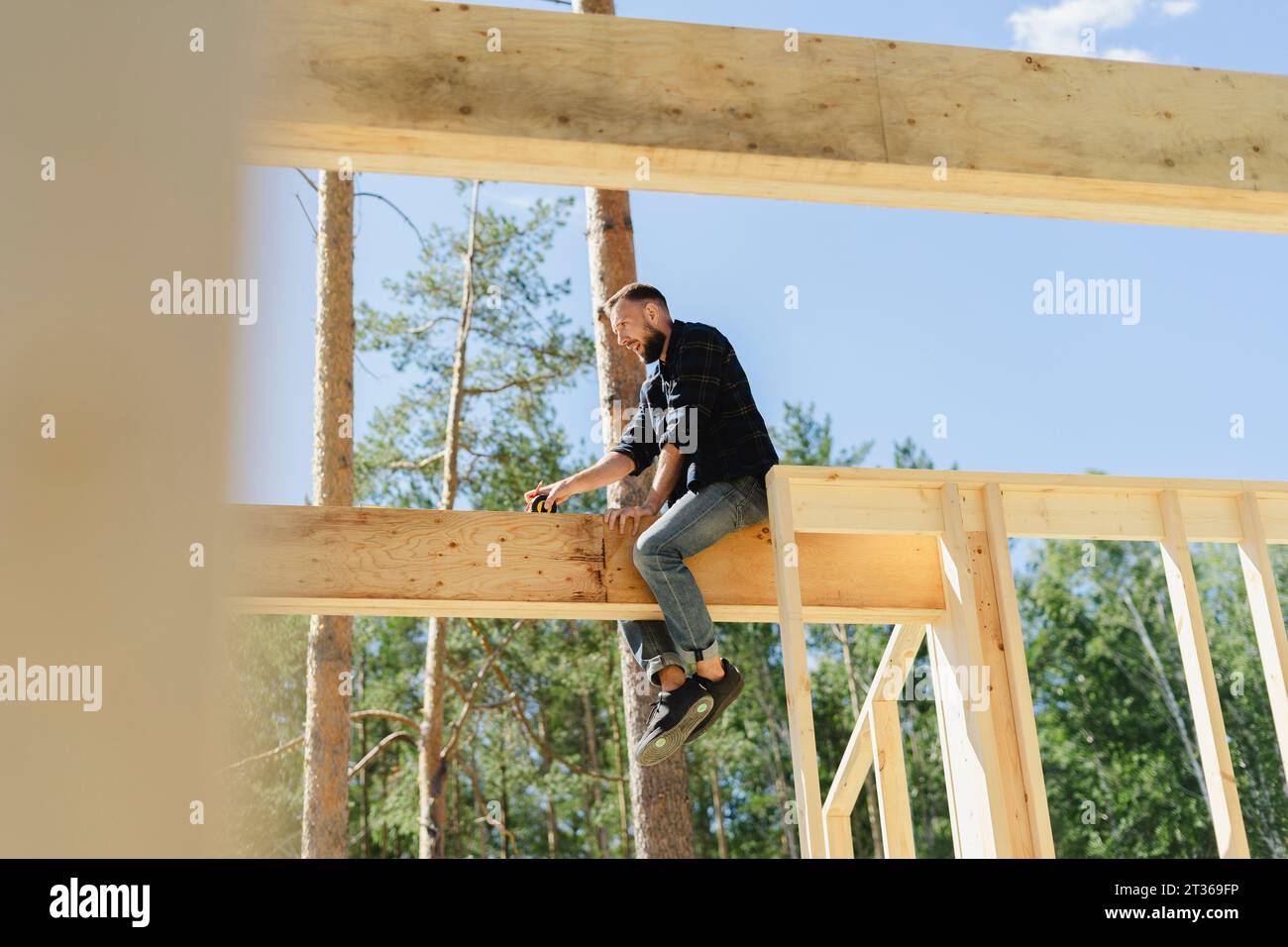 Engineer sitting on wooden frame on sunny day Stock Photo - Alamy