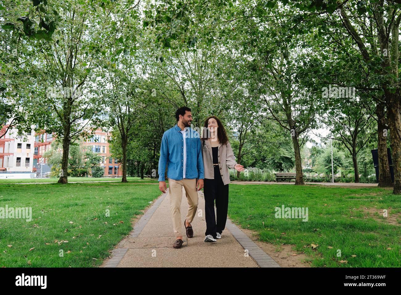 Happy men walking talking hi-res stock photography and images - Alamy