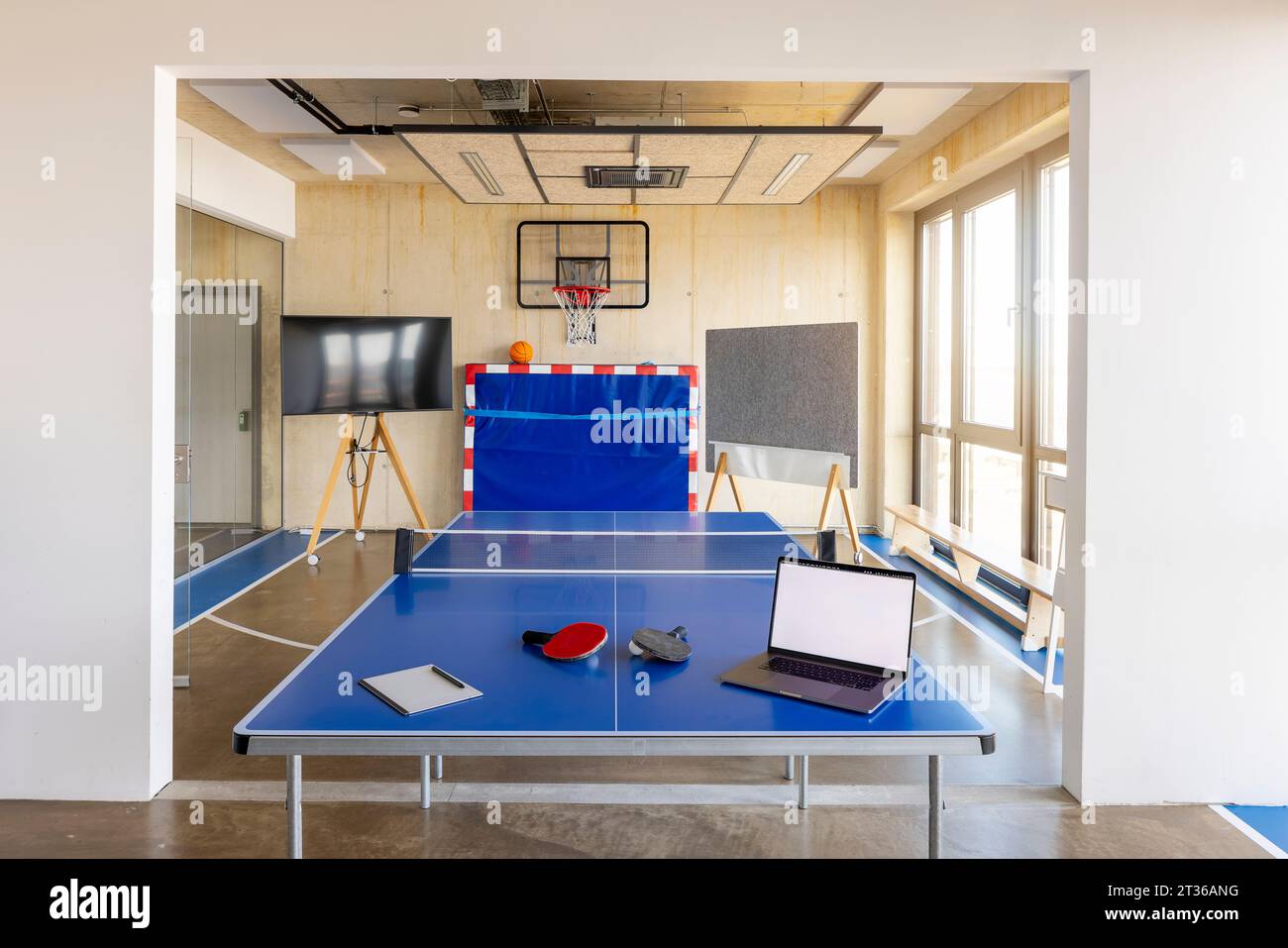 Laptop kept on tennis table in modern office Stock Photo - Alamy