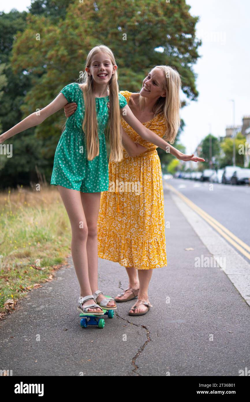 Woman helping children hi-res stock photography and images - Alamy