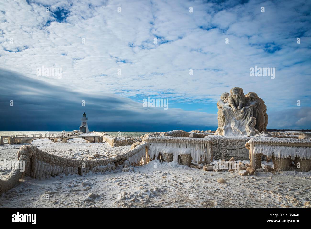 thick Ice formations over the monument and the guard rails in the pier ...