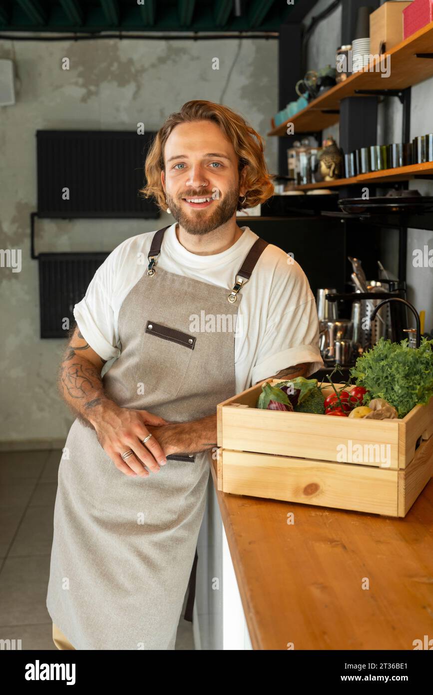 Owner wearing apron standing hi-res stock photography and images - Alamy