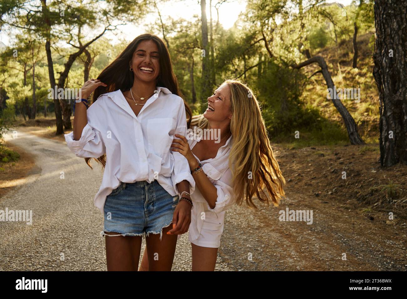 Cheerful mother enjoying sunset in forest with daughter Stock Photo - Alamy