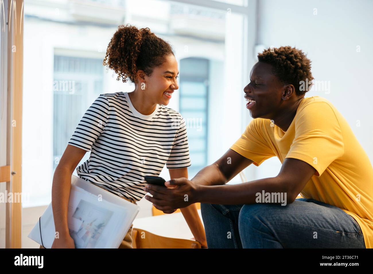Happy friends spending time together at university Stock Photo - Alamy