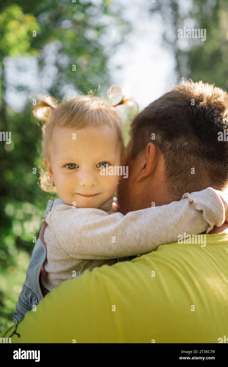 Father carrying his child on arm hi-res stock photography and images - Alamy