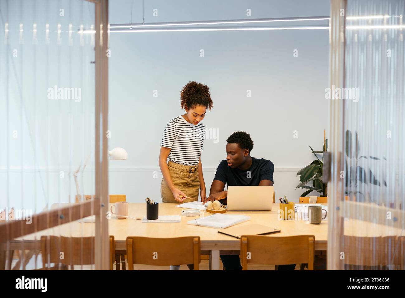 Students having discussion together over document at university Stock ...