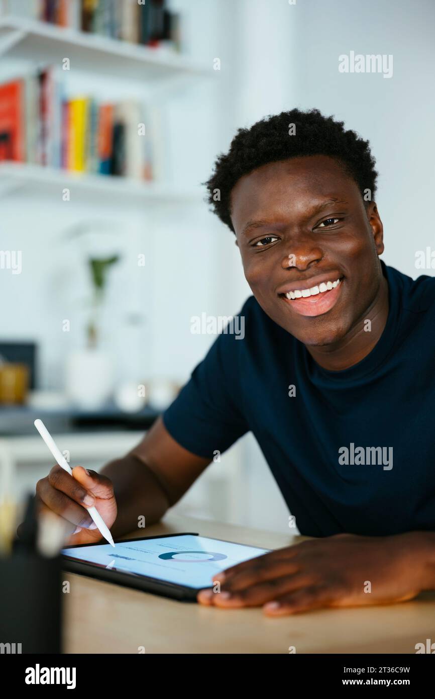 Happy student sitting table hi-res stock photography and images - Alamy