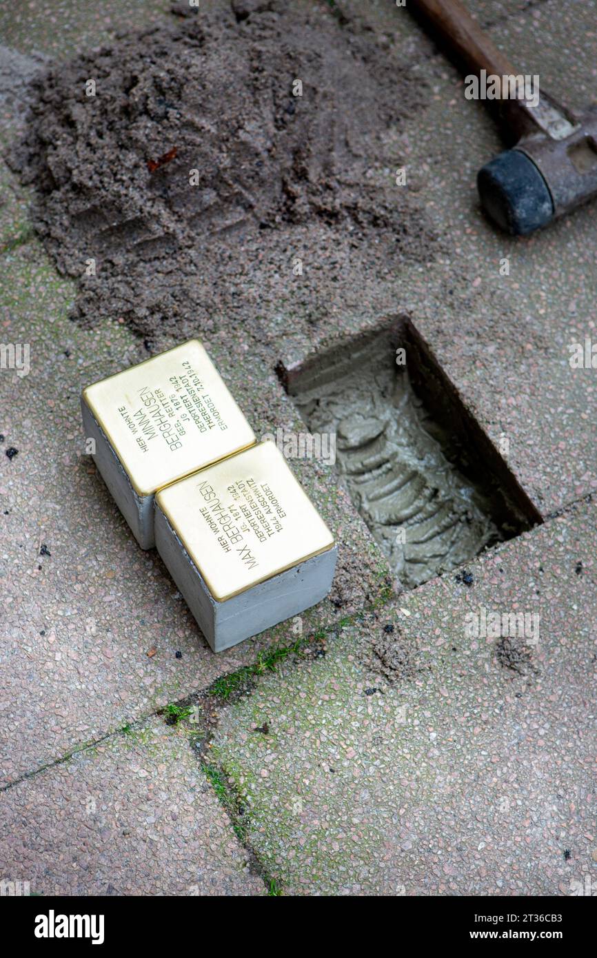 Wiesbaden, Germany - October 17, 2023: A bricklayer lays Stolpersteine ...