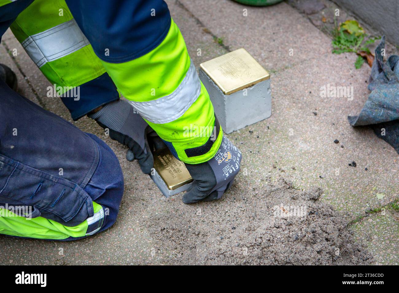 Wiesbaden, Germany - October 17, 2023: A bricklayer lays Stolpersteine ...