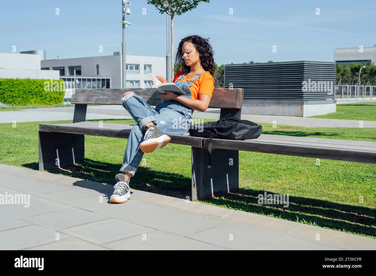 Student sitting on bench in hi-res stock photography and images - Alamy