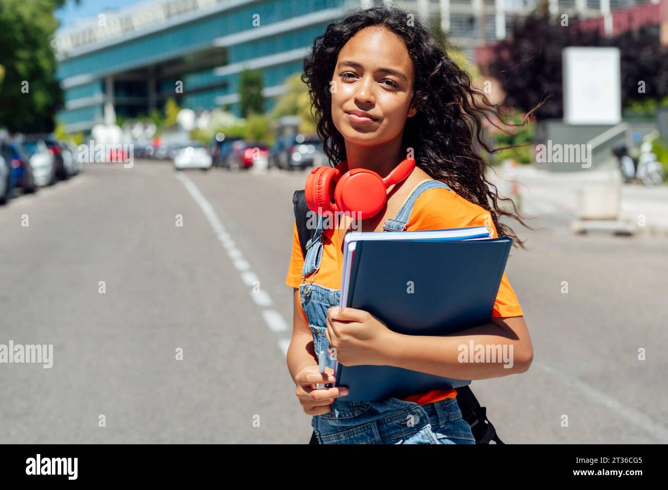 Young student holding books hi-res stock photography and images - Alamy