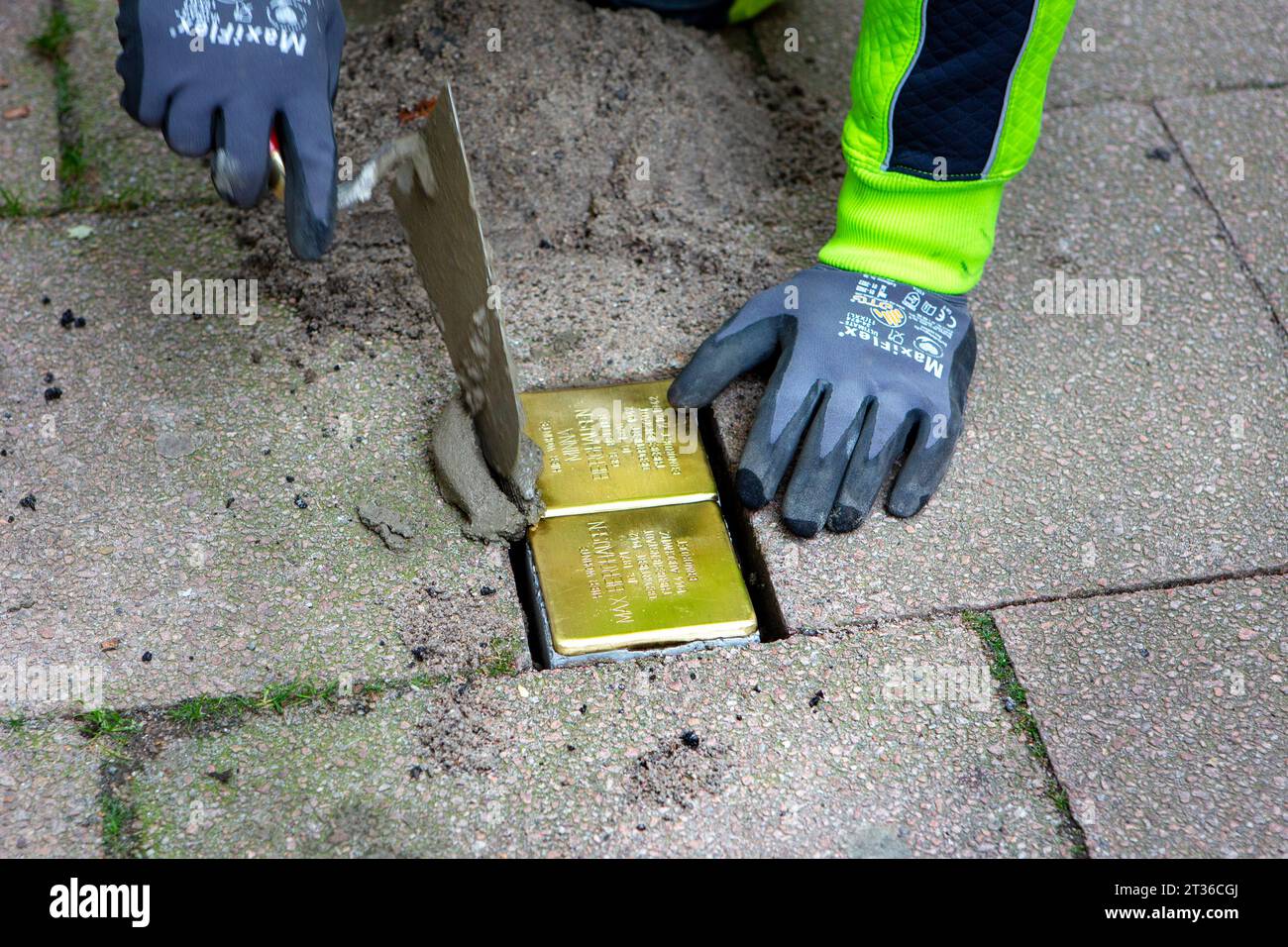 Wiesbaden, Germany - October 17, 2023: A bricklayer lays Stolpersteine ...
