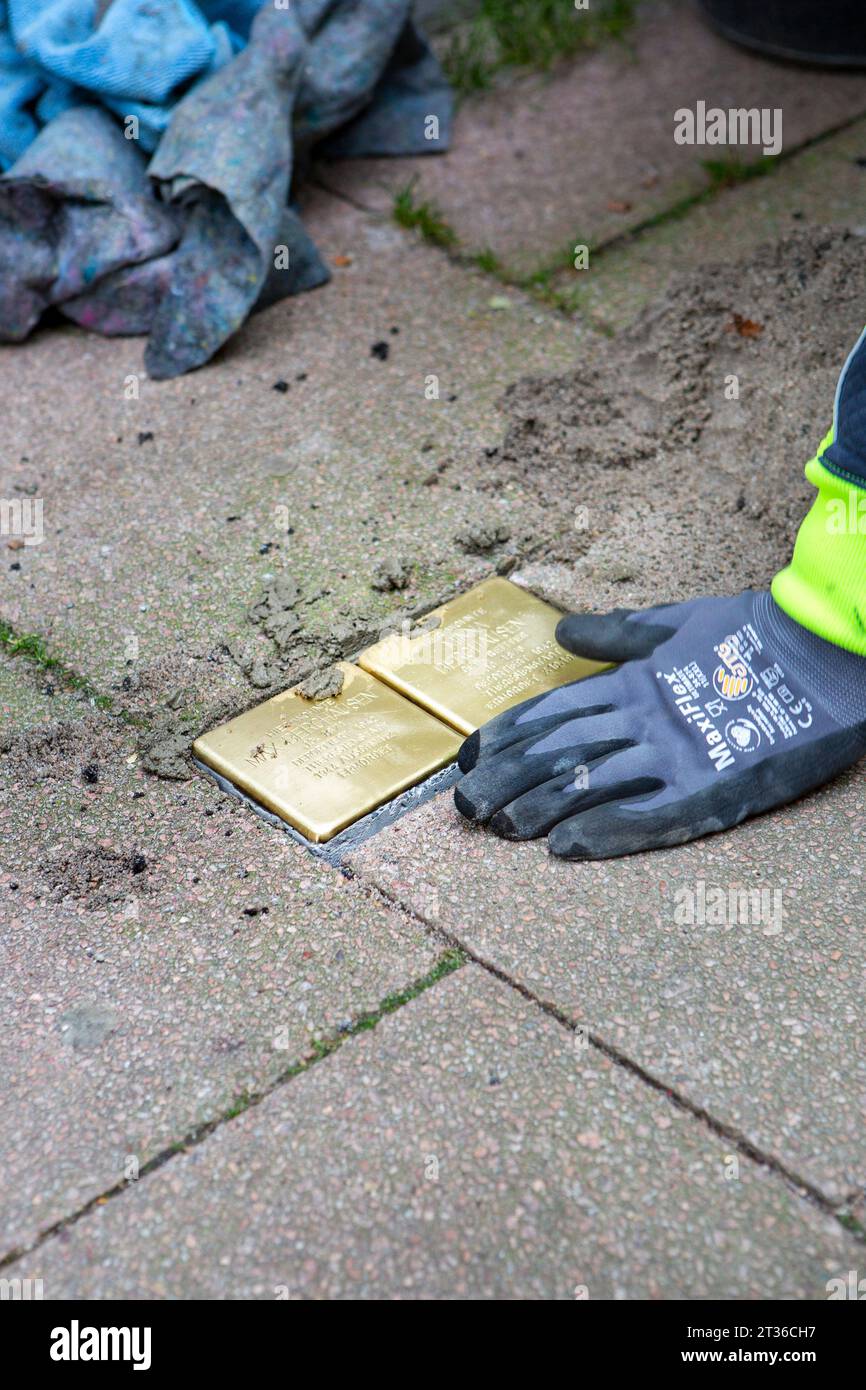 Wiesbaden, Germany - October 17, 2023: A bricklayer lays Stolpersteine ...