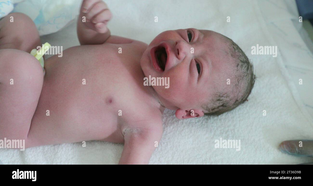 Newborn baby after birth crying Stock Photo - Alamy