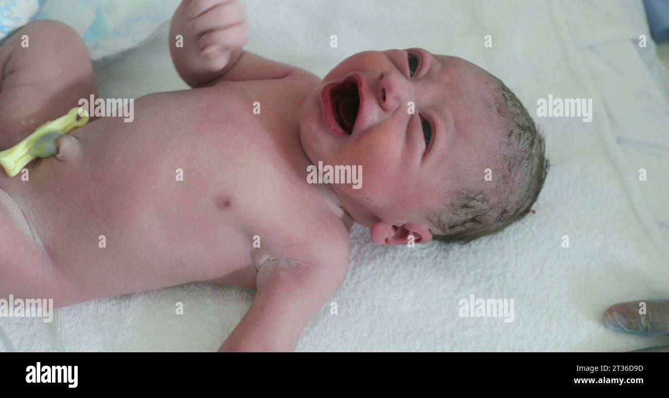 Newborn baby after birth crying Stock Photo - Alamy