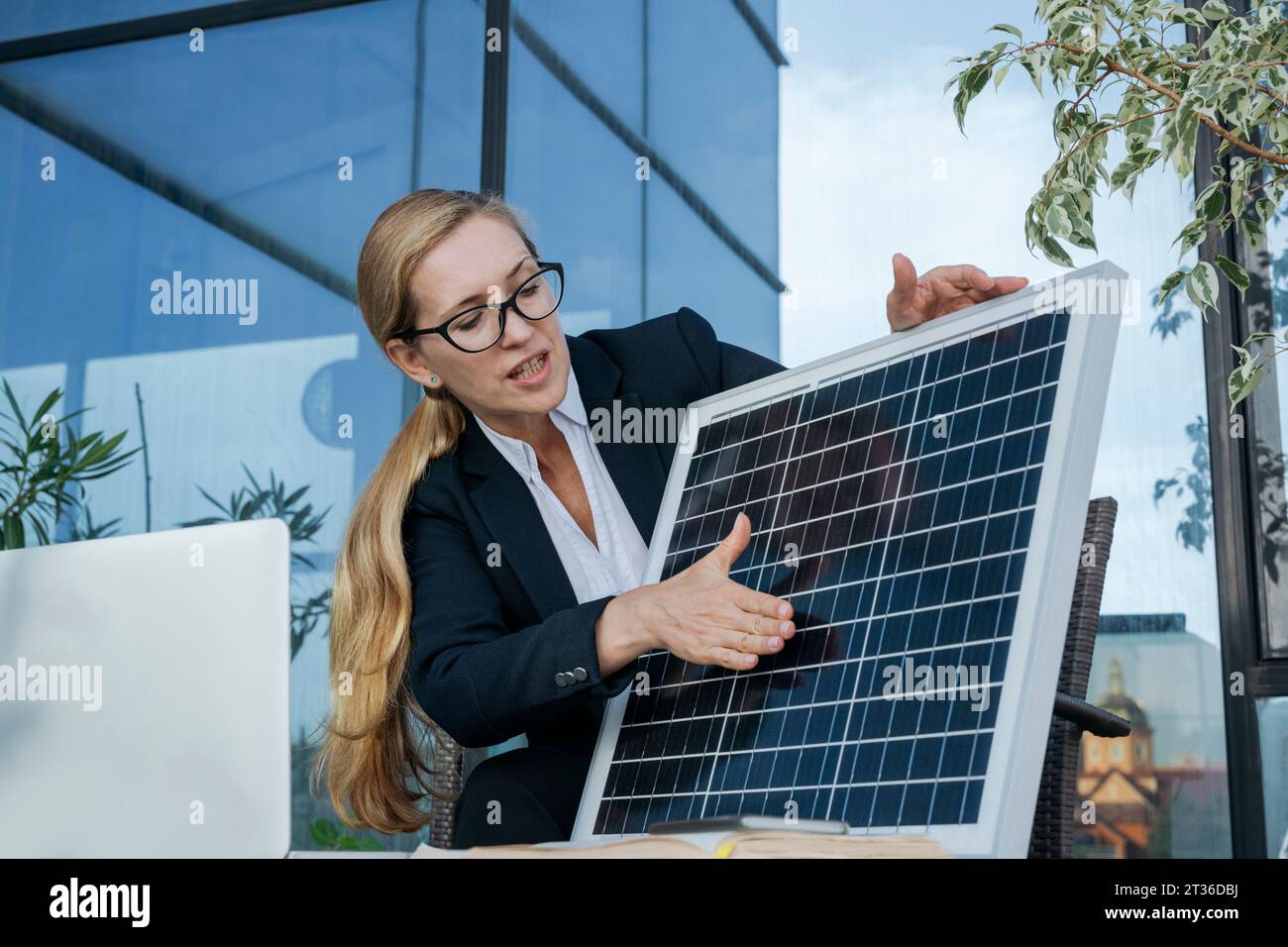 Businesswoman giving presentation about solar panel over video call on ...