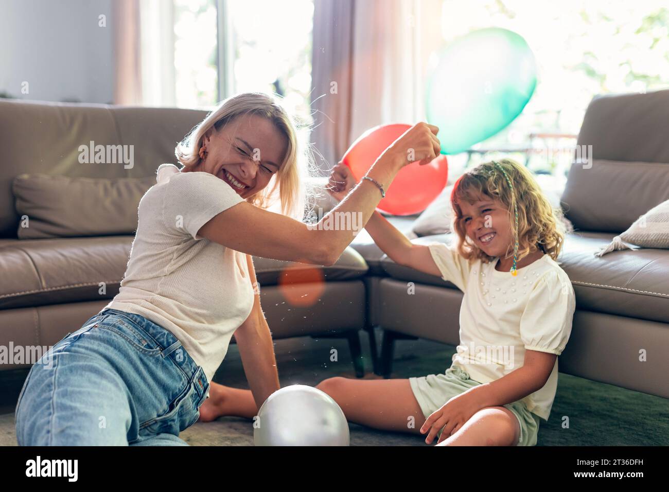 Two children playing balloons hi-res stock photography and images - Alamy
