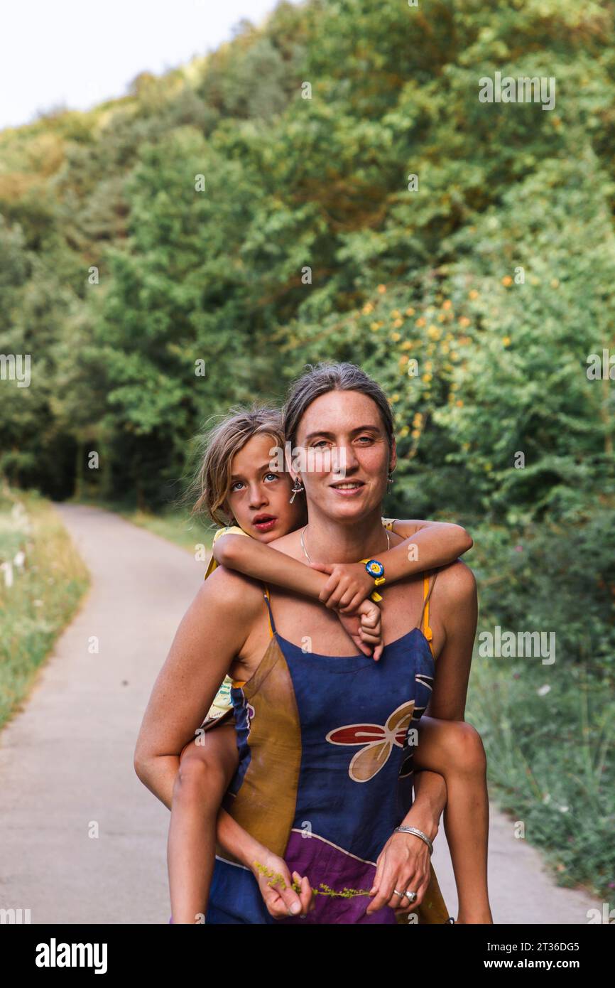 Happy mother giving piggyback ride to son in forest Stock Photo - Alamy Happy mother giving piggyback ride to son in forest Stock Photo - Alamy
