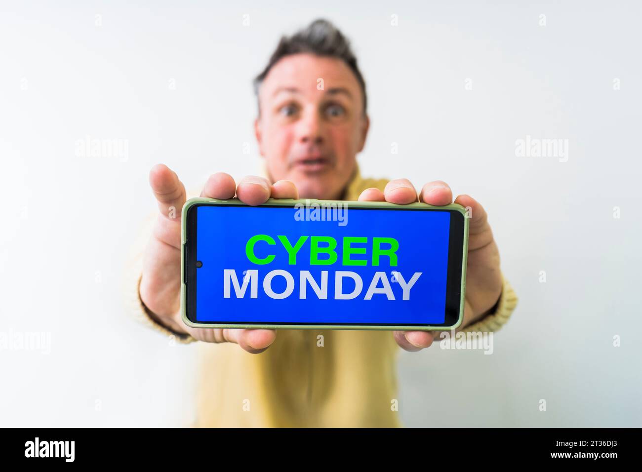 Crazy man holding mobile phone with Cyber Monday advertisement on the ...