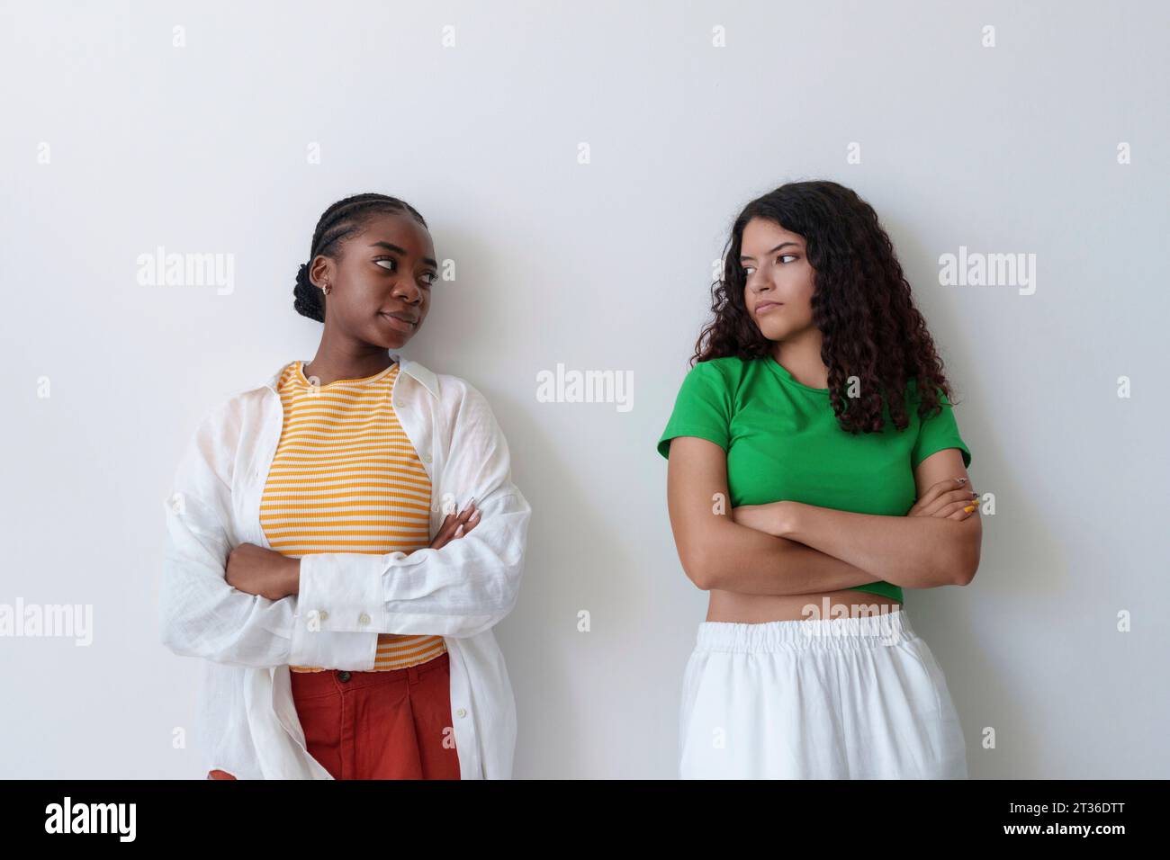 Angry friends with arms crossed standing in front of wall Stock Photo ...
