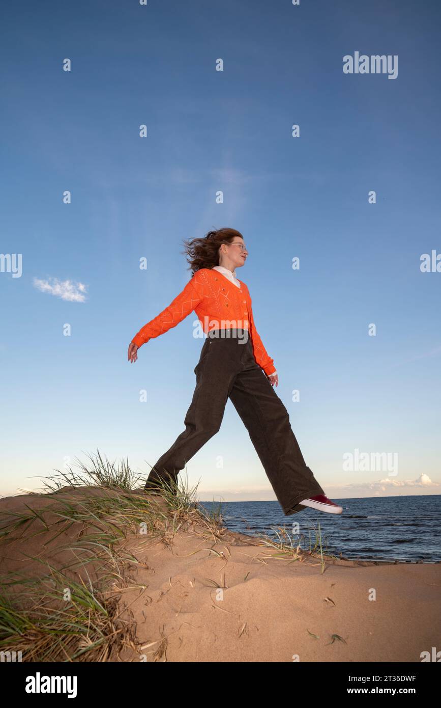 Young woman walking sand dune beach hi-res stock photography and images ...