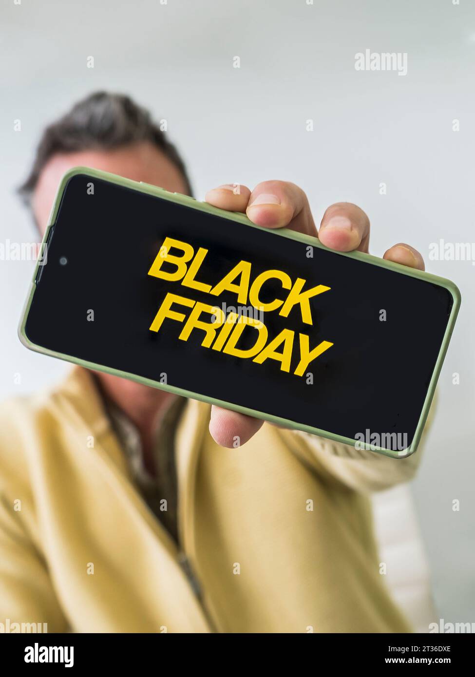 Unseen man holding mobile phone with Black Friday advertisement on the ...