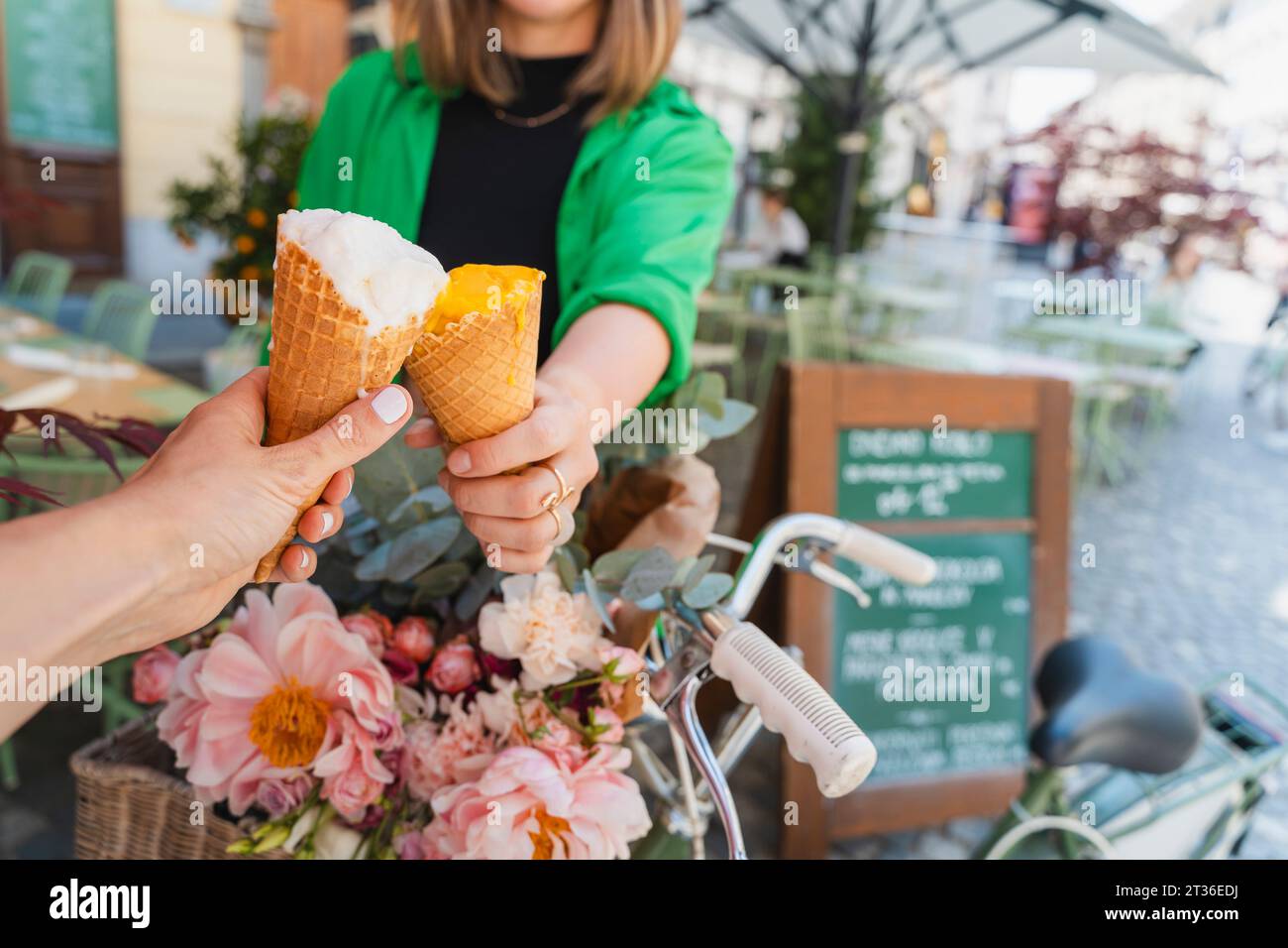 Women with ice cream cones in sidewalk cafe Stock Photo - Alamy