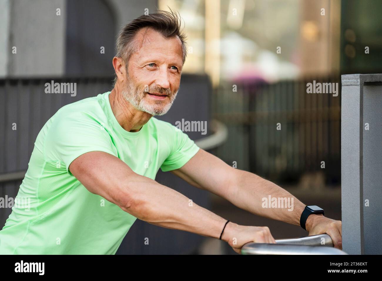 Determinant athlete doing exercise on railing Stock Photo - Alamy