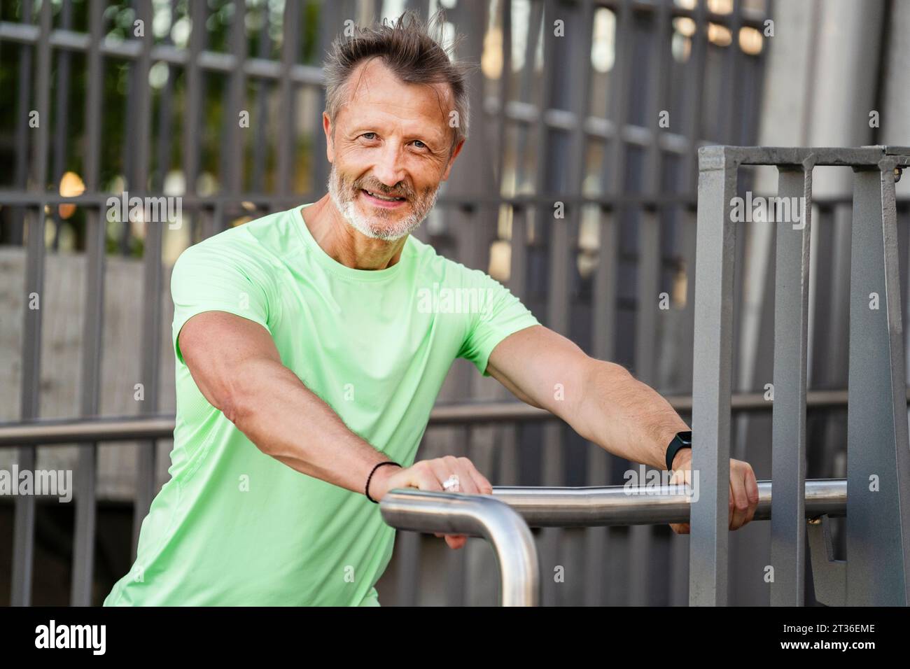 Athlete practicing warm up exercise on railing Stock Photo - Alamy