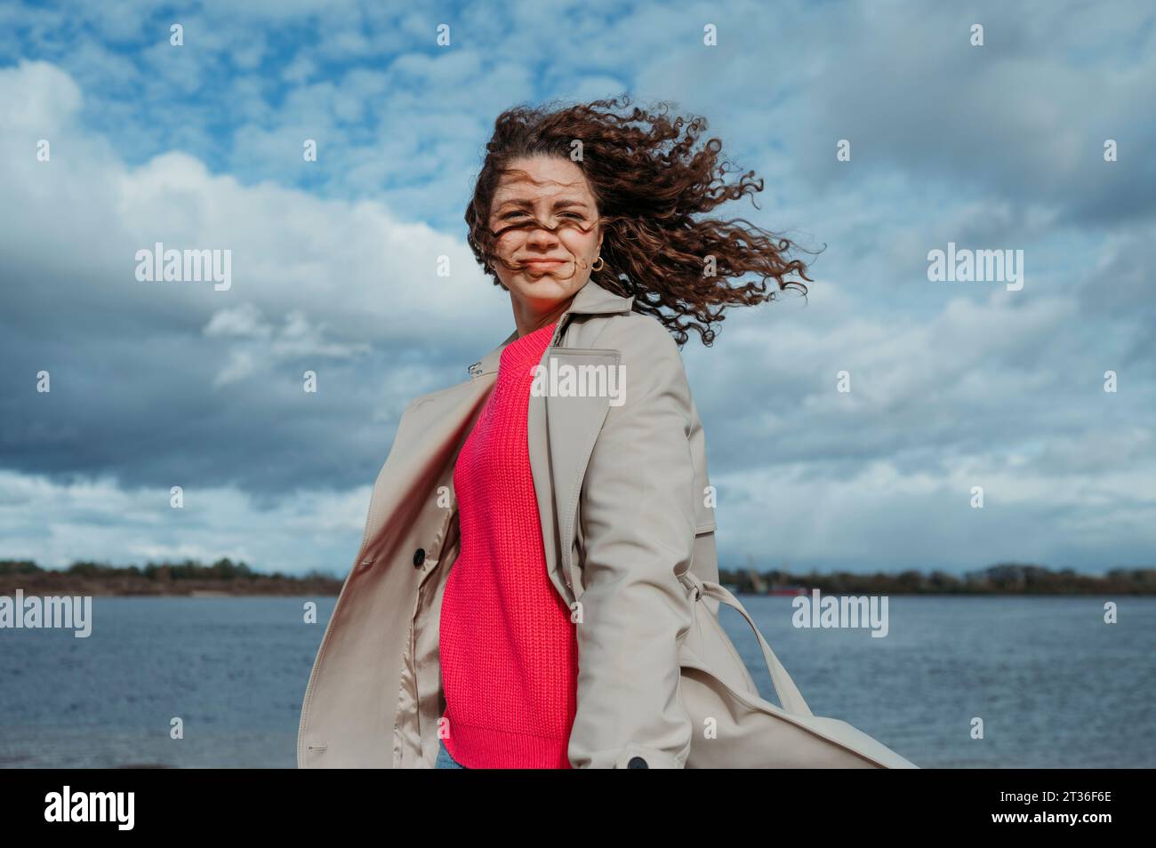 Woman standing tousled hair hi-res stock photography and images - Alamy