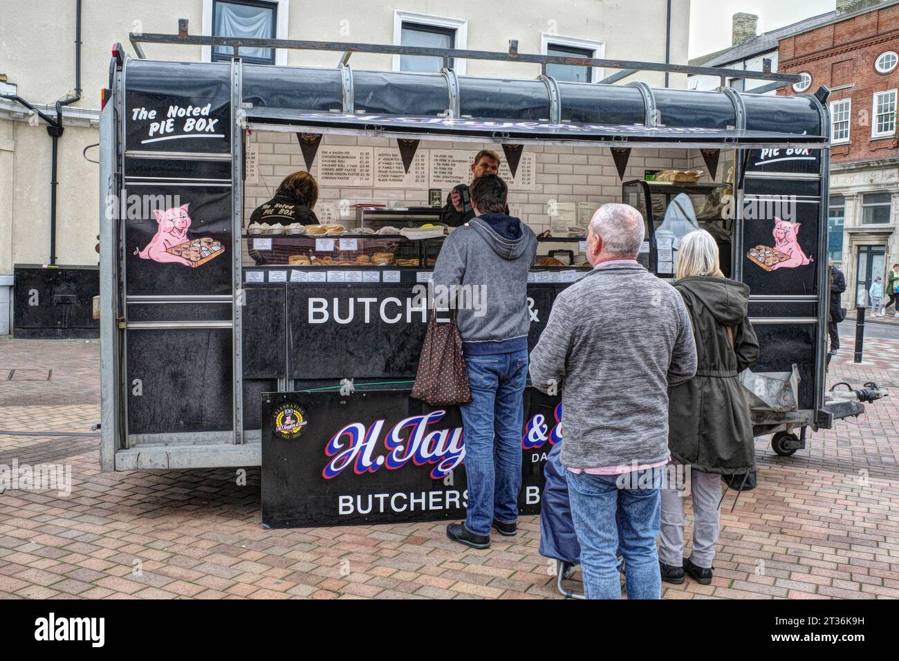 Customers buying from H Taylor and Sons meat and pie stall iin the ...