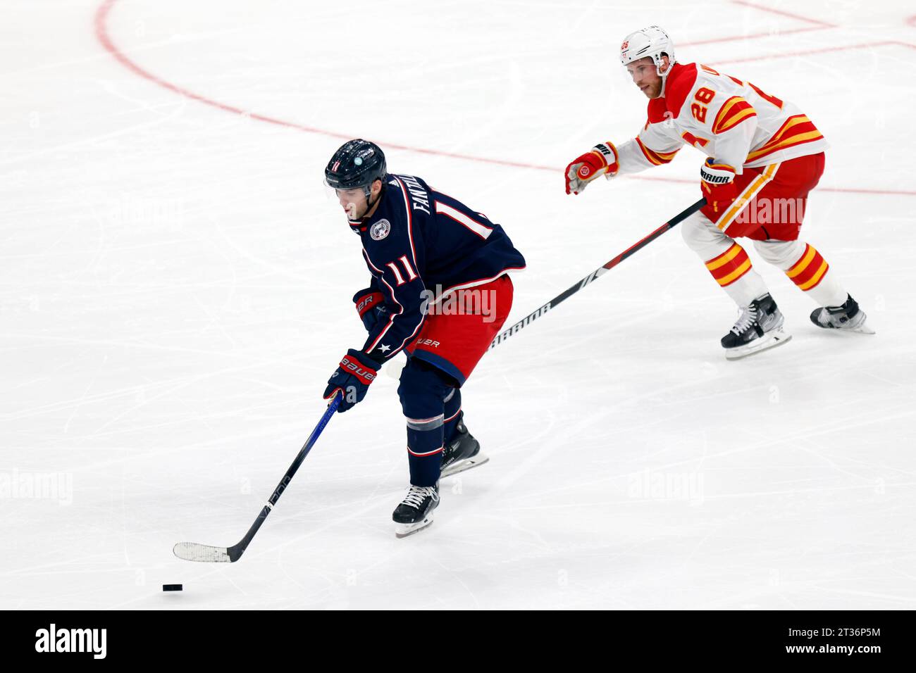 Columbus Blue Jackets forward Adam Fantilli, left, controls the puck in ...