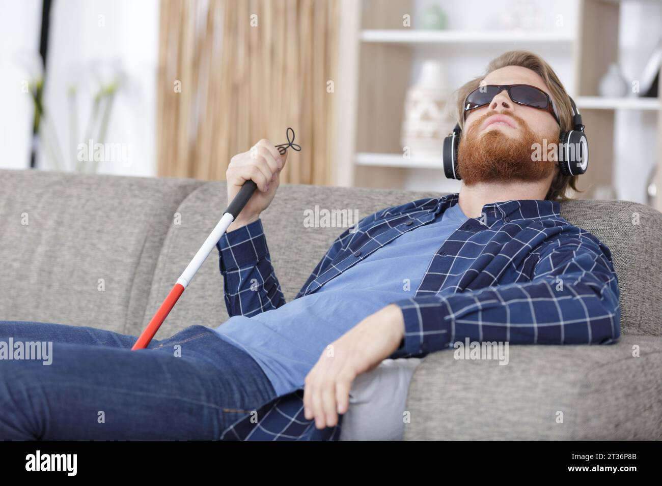 blind man sitting on sofa at home Stock Photo - Alamy