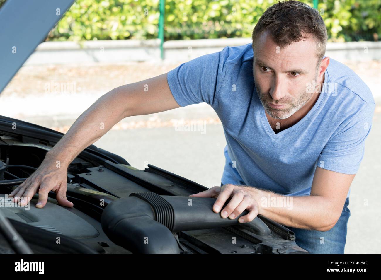 worried man examining his car engine parked Stock Photo - Alamy