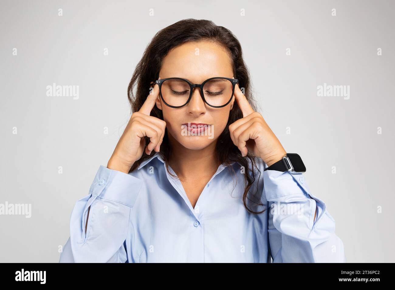 Angry sad adult european woman in formal wear and glasses pressing ...
