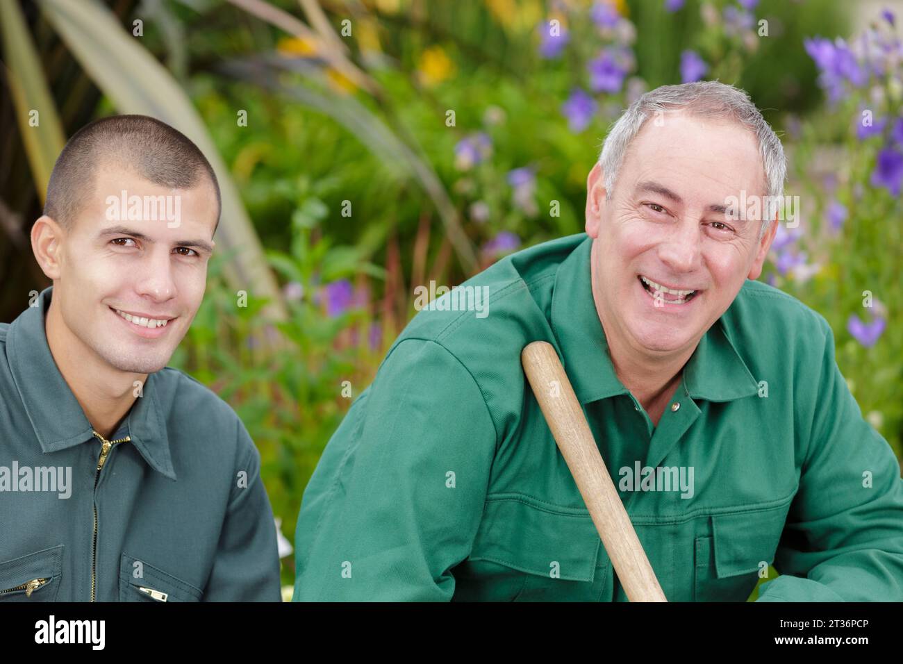 happy gardeners talking at plant nursery Stock Photo - Alamy
